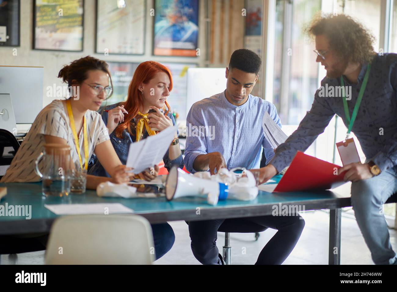 Group of young employees working together at the office Stock Photo - Alamy