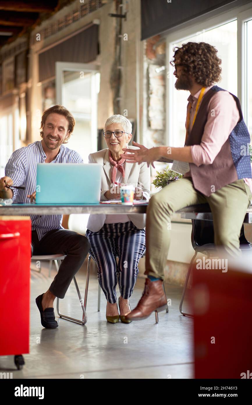Group of young work colleagues consulting with senior colleague Stock ...