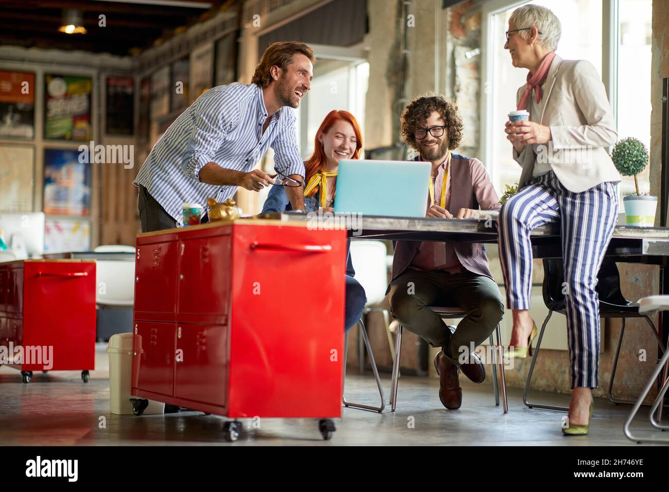 Group of young employees consulting with senior colleague Stock Photo ...