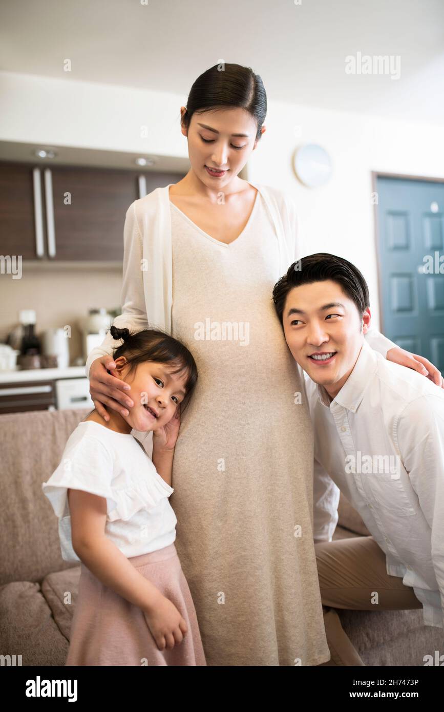 Father and daughter listening to the unborn child Stock Photo - Alamy