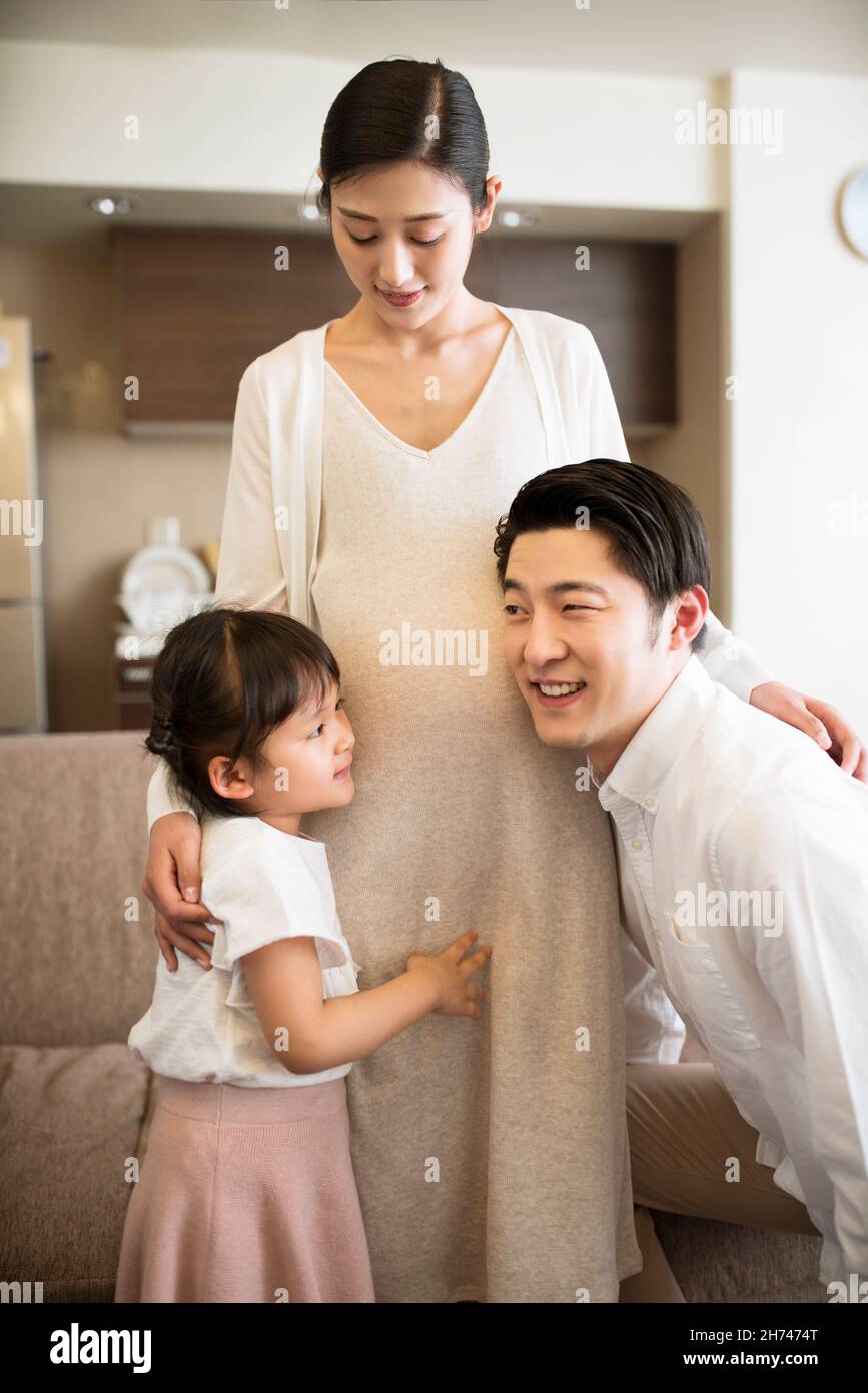Father and daughter listening to the unborn child Stock Photo - Alamy