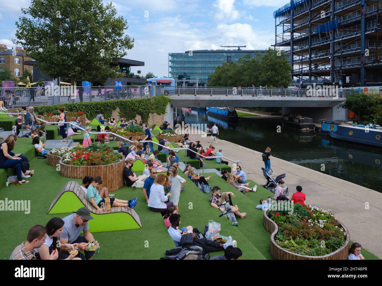 People relaxing on the wide south-facing green steps next to Regent's ...