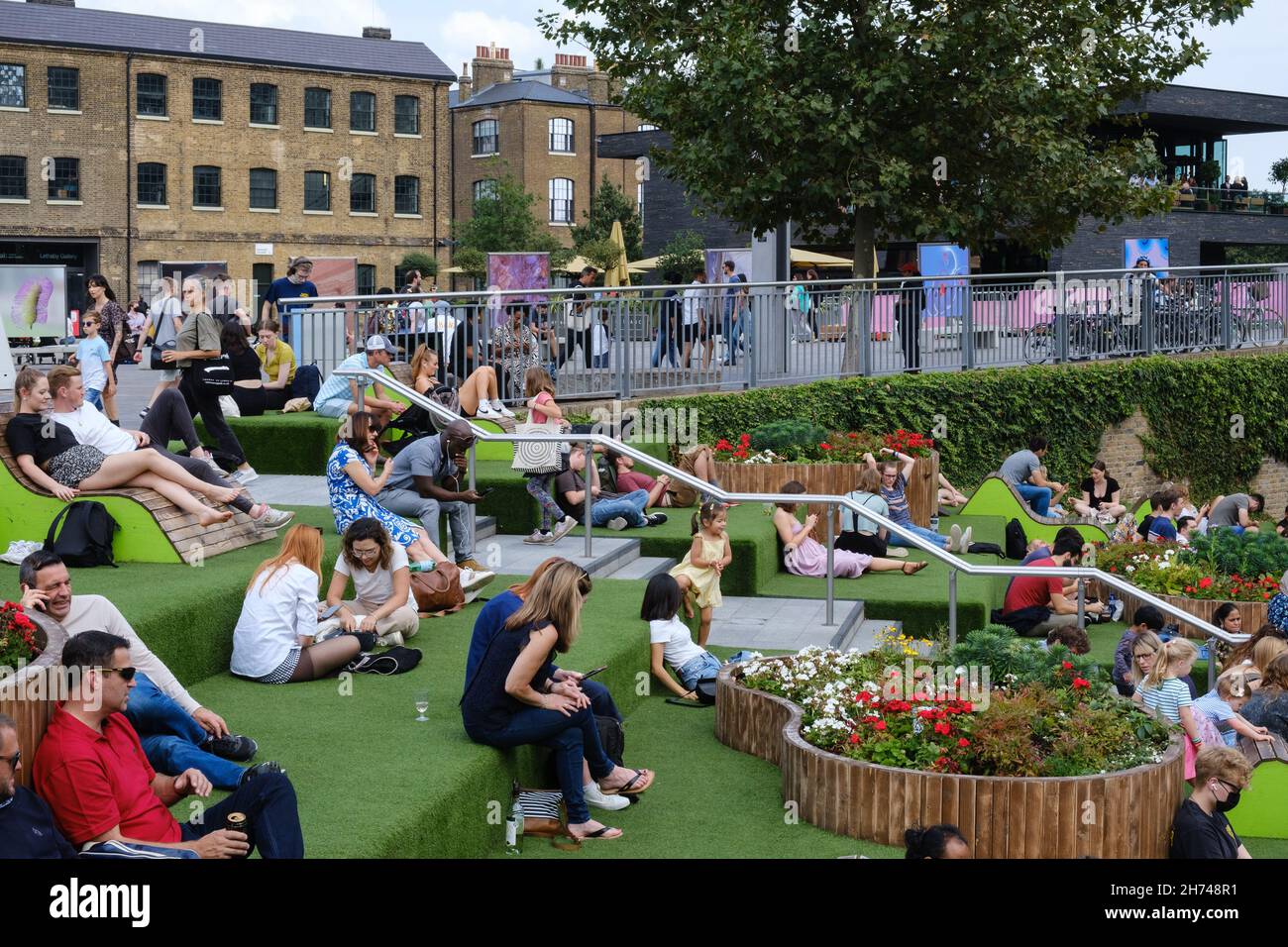 People relaxing on the wide south-facing green steps next to Regent's ...