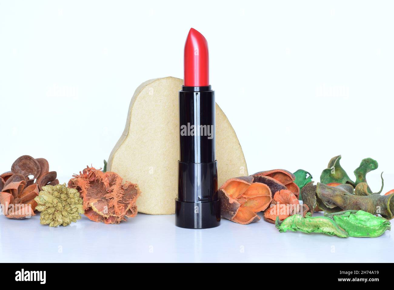 Red lipstick on the table with its natural ingredients isolated on a ...