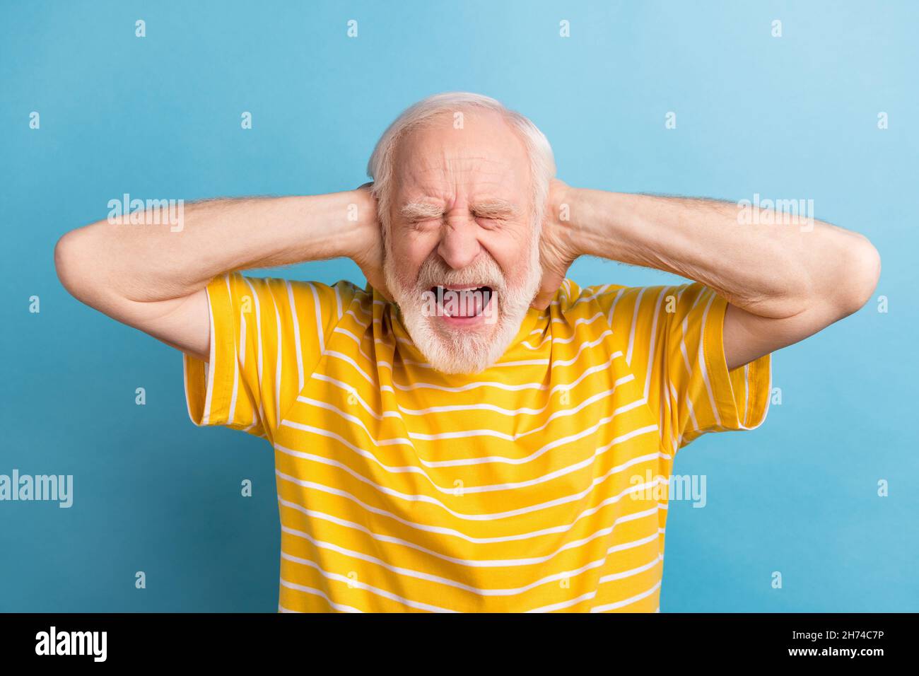 Portrait of nice outraged evil gray-haired man screaming closing ears ...
