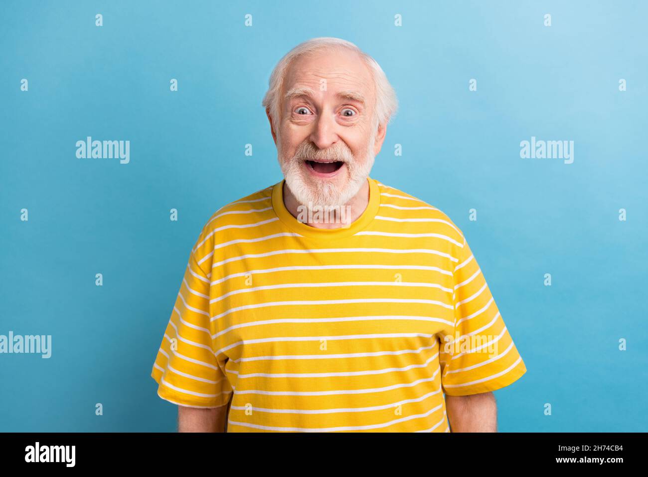 Portrait of nice amazed gray-haired man wearing yellow tshirt good news ...