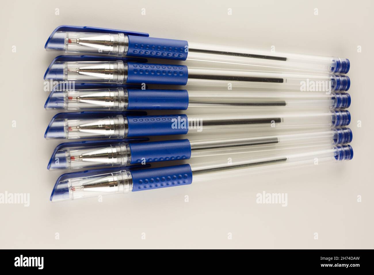 set of blue ballpoint pens lined up hardly on a white background Stock ...