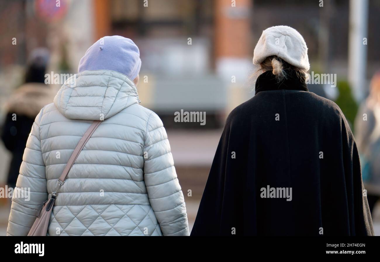 Back view of two women walking away at street Stock Photo - Alamy