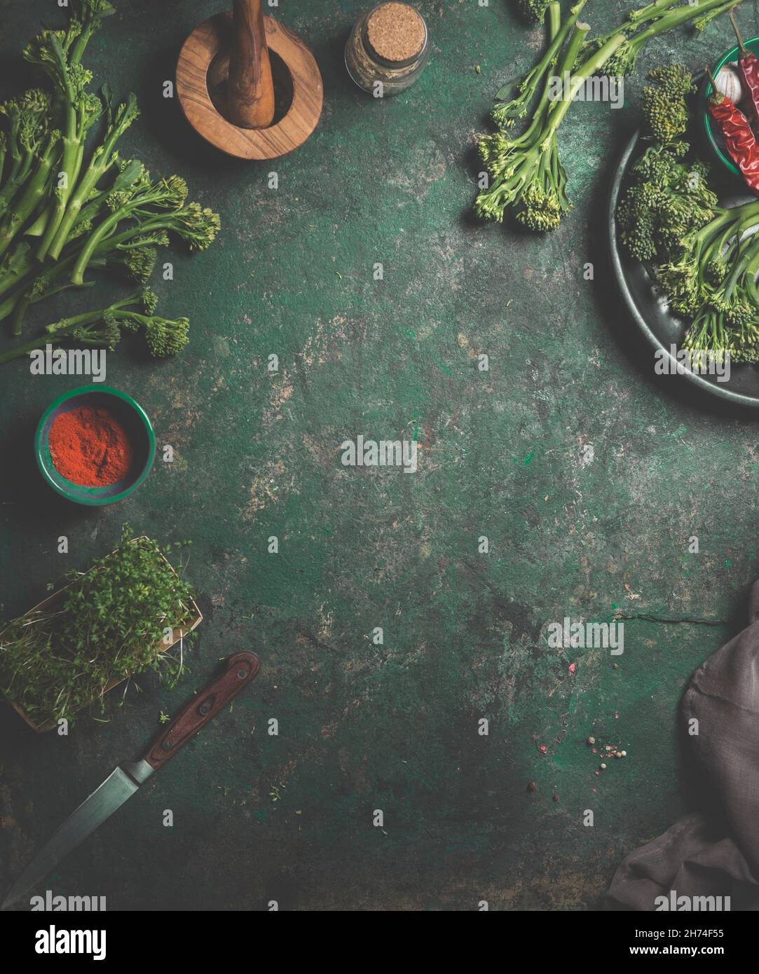 Dark green food background with kitchen knife, mortar and pestle ...