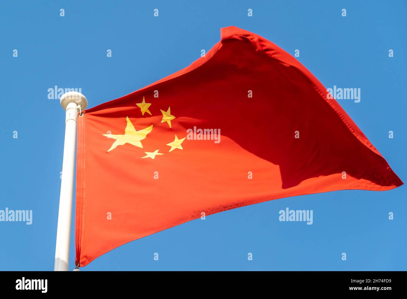 China Flag hanging and blowing in sunshine on blue sky background Stock ...