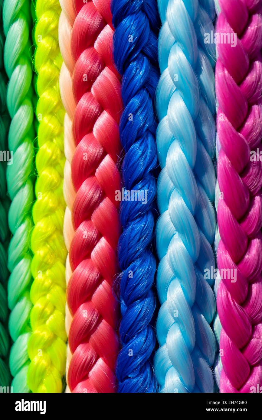 Colorful synthetic hair braids and extensions. Colorful hair styling ...