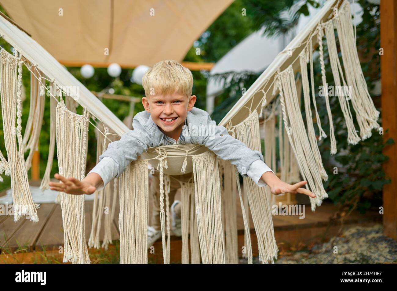 Little boy poses on hammock, summer camping Stock Photo - Alamy