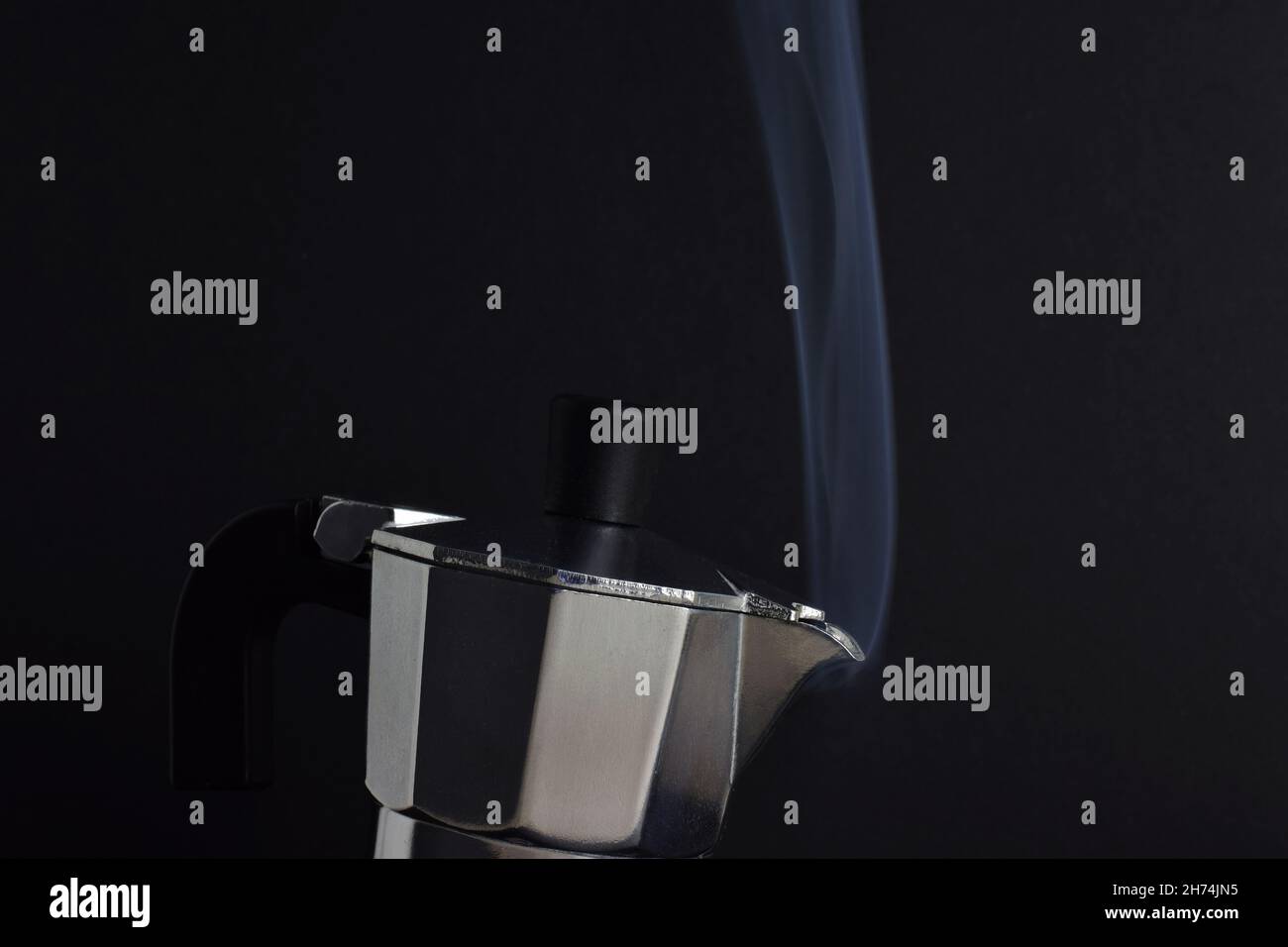 Steam of coffee boiling in a Moka pot in the black backgo=round Stock ...