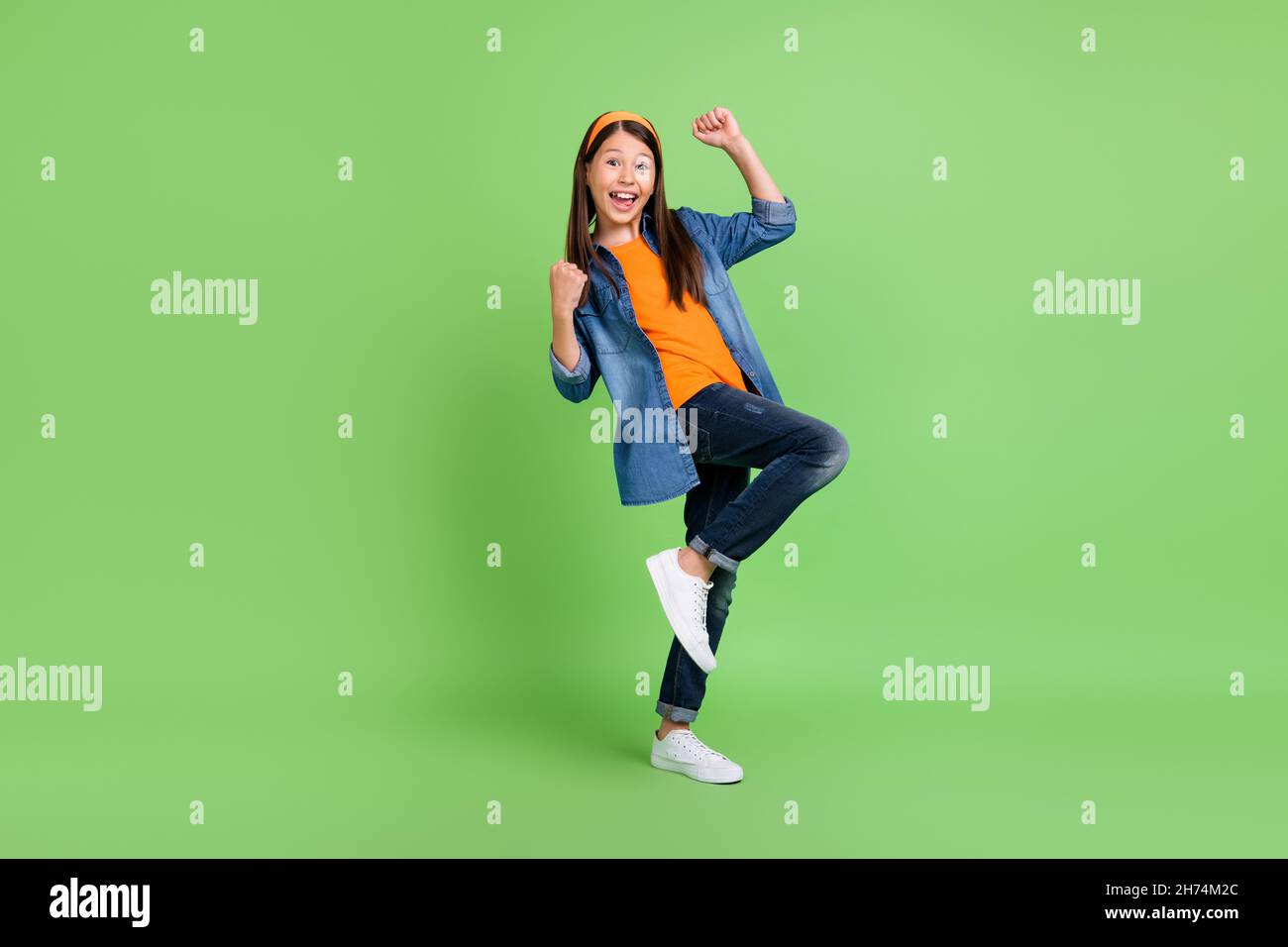 Full body photo of hooray small girl hands fists wear hoop shirt jeans ...