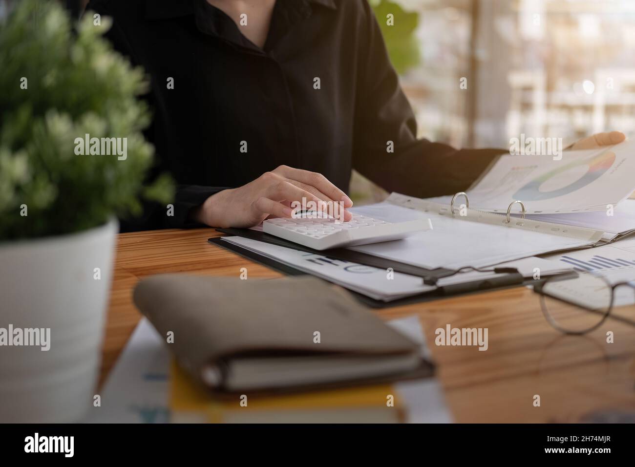 Close up a accountant working about financial with calculator at his ...