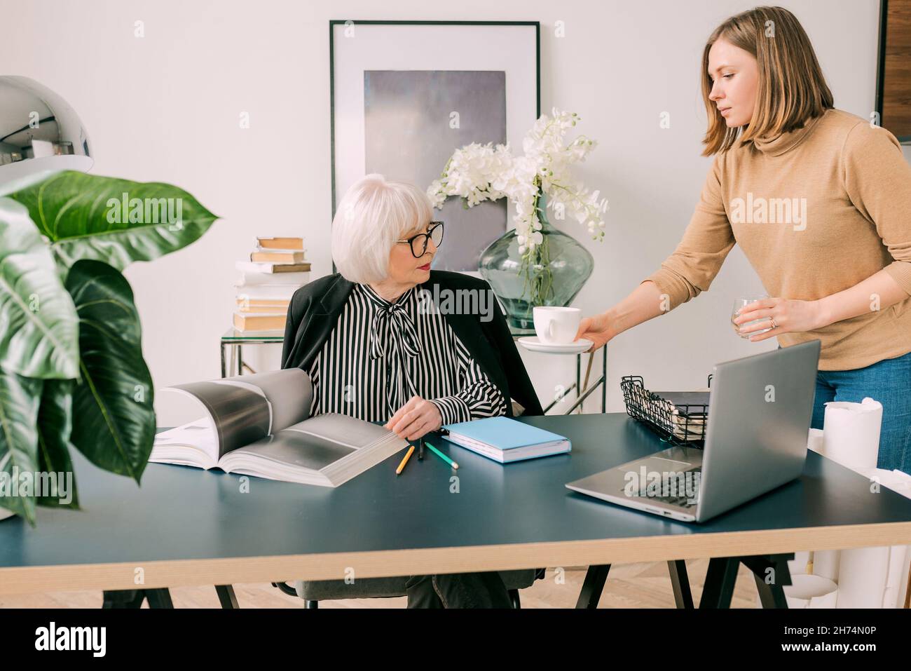 young assistant brought a coffee to the boss in office. Business ...