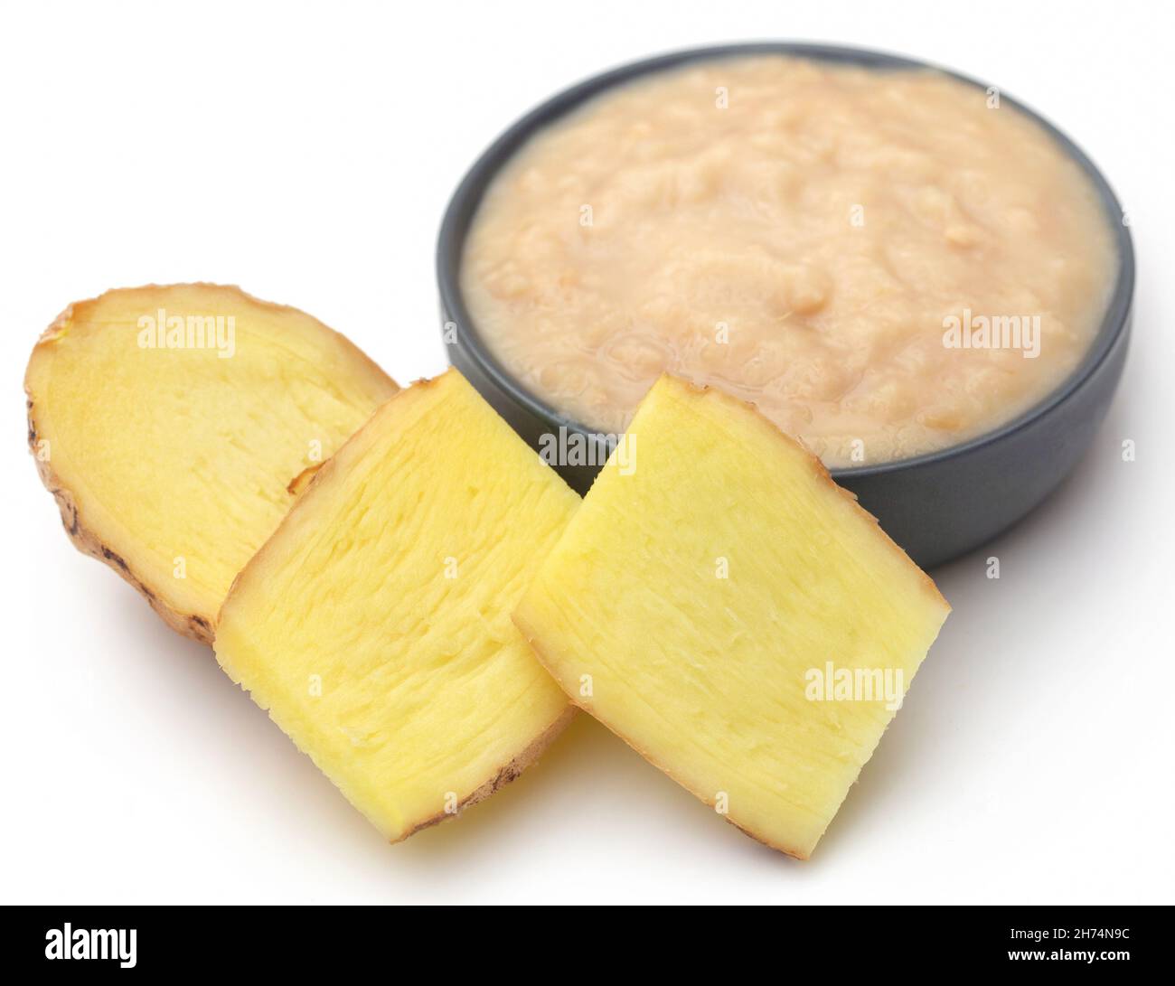 Ginger with paste over white background Stock Photo - Alamy