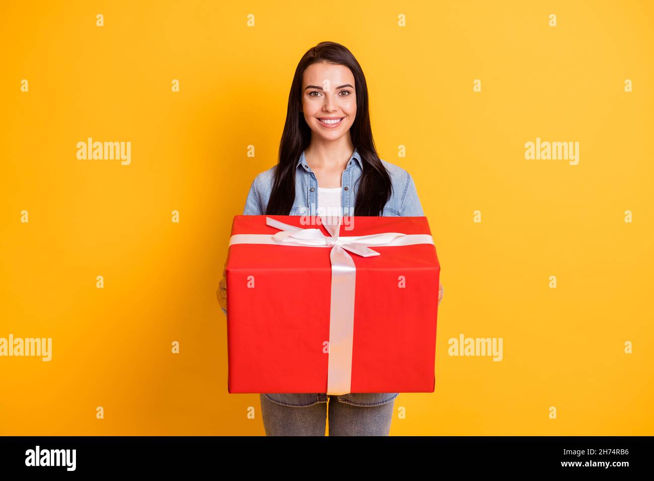 Portrait of nice optimistic brunette lady hold present wear blue shirt ...