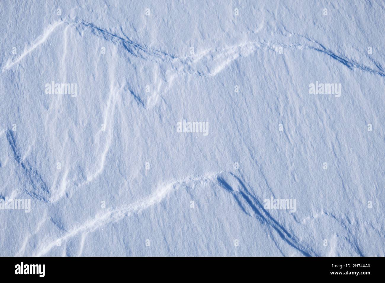 Natural snow background with drawings of mountains made by the wind ...