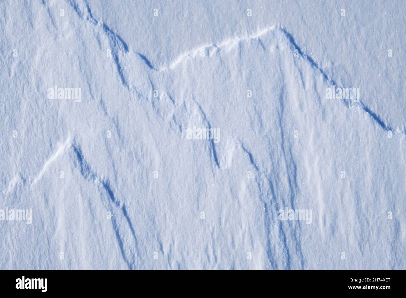 Natural snow background with drawings of mountains made by the wind ...