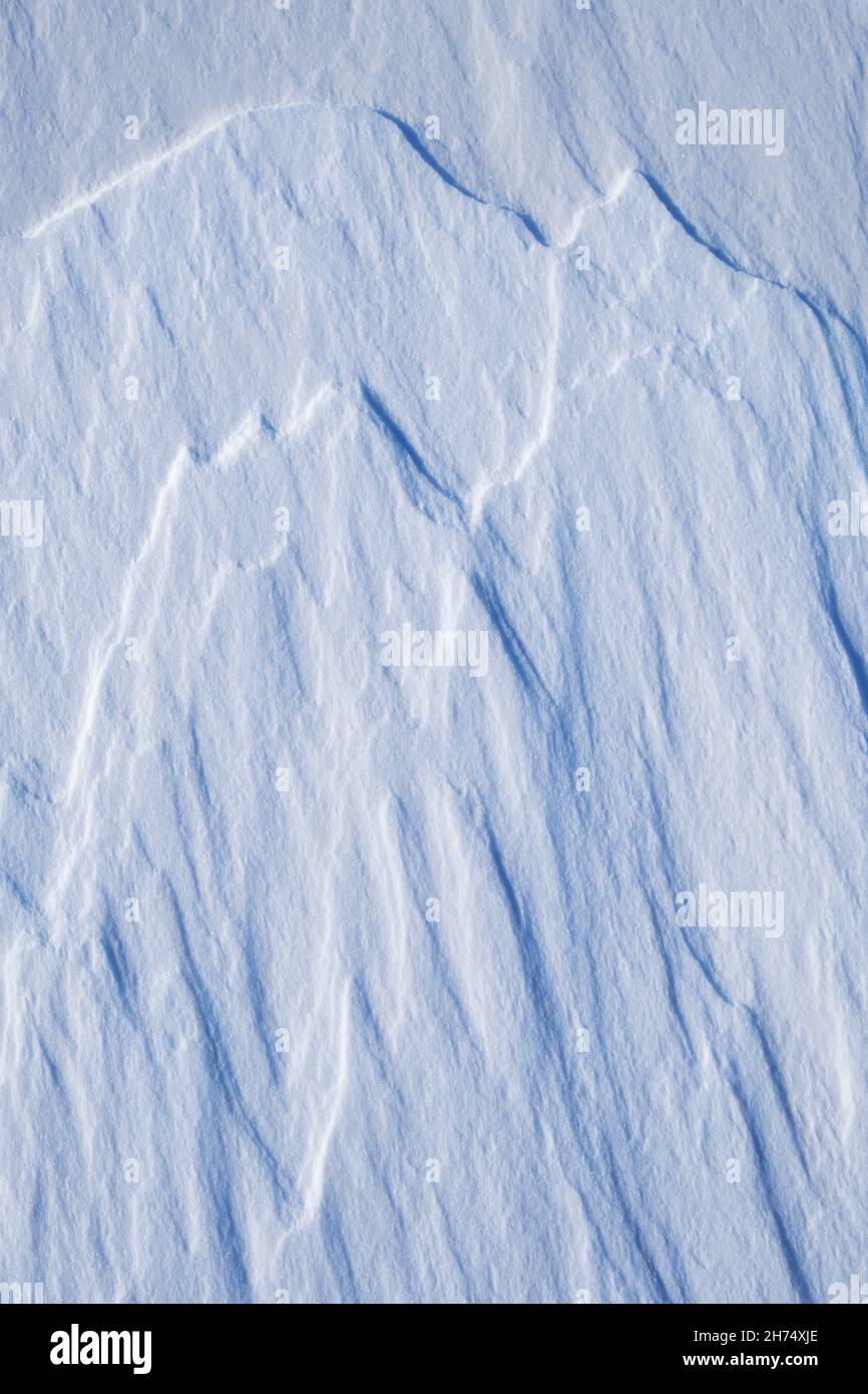 Natural snow background with drawings of mountains made by the wind ...