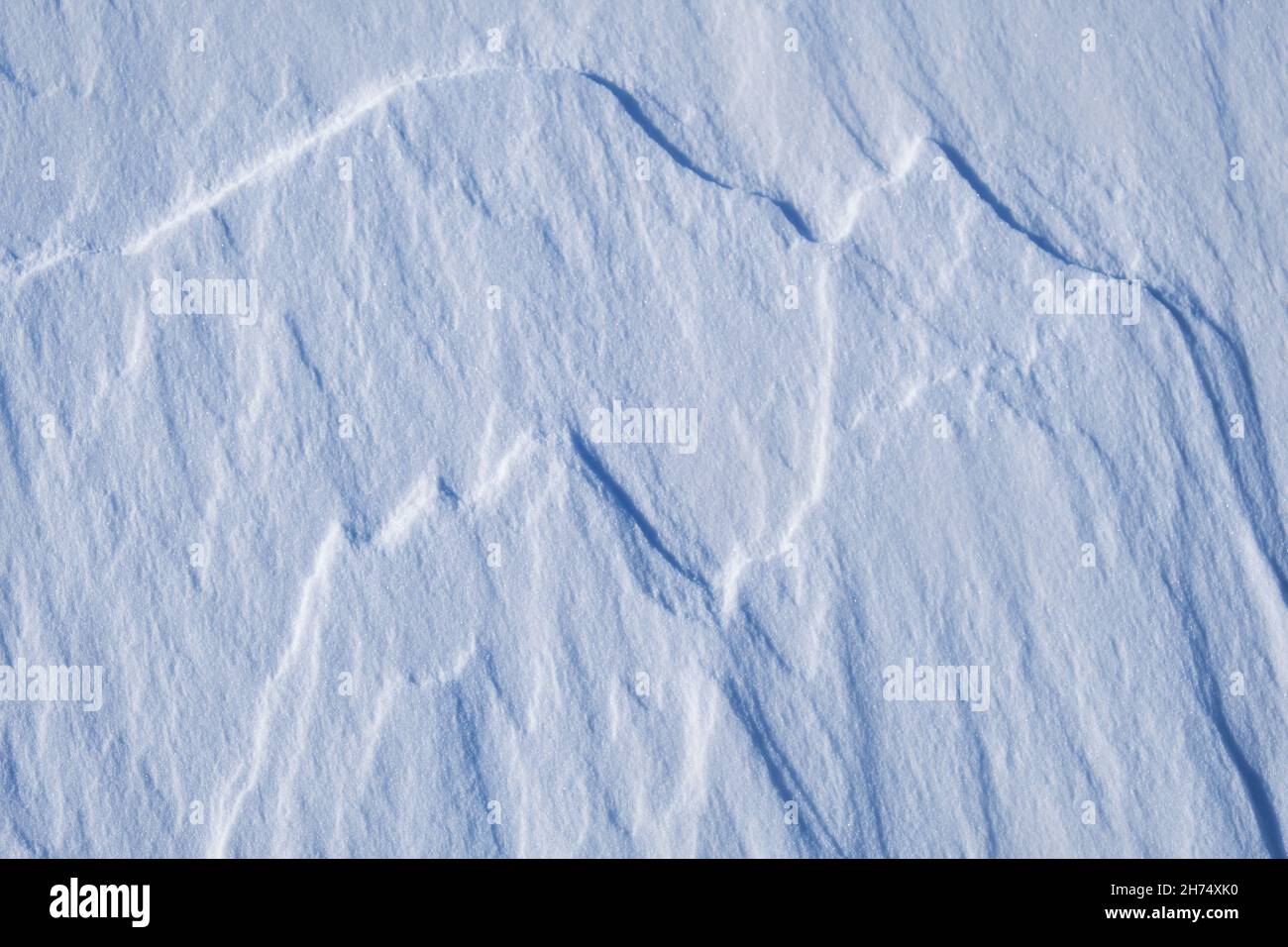 Natural snow background with drawings of mountains made by the wind ...