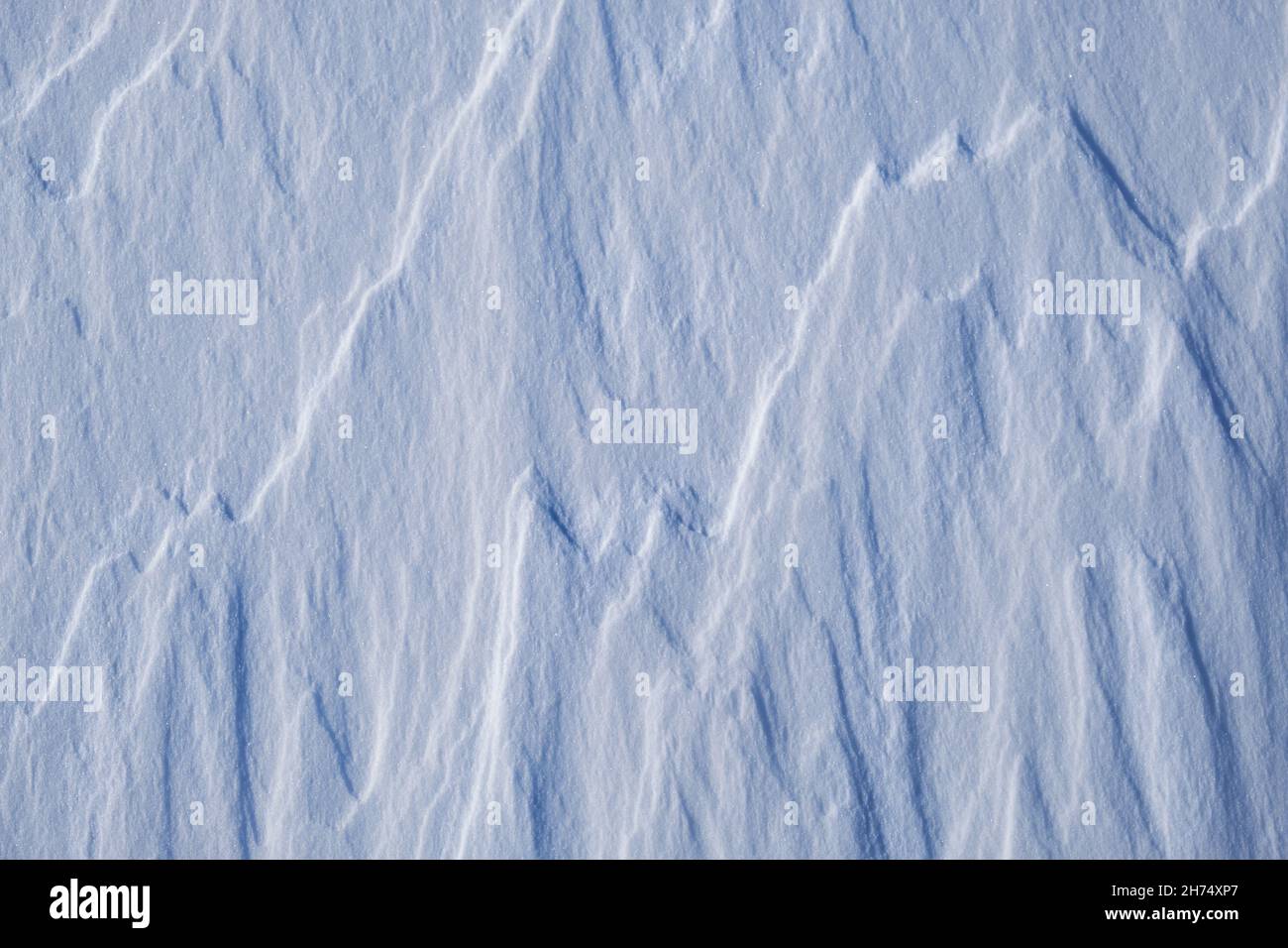 Natural snow background with drawings of mountains made by the wind ...