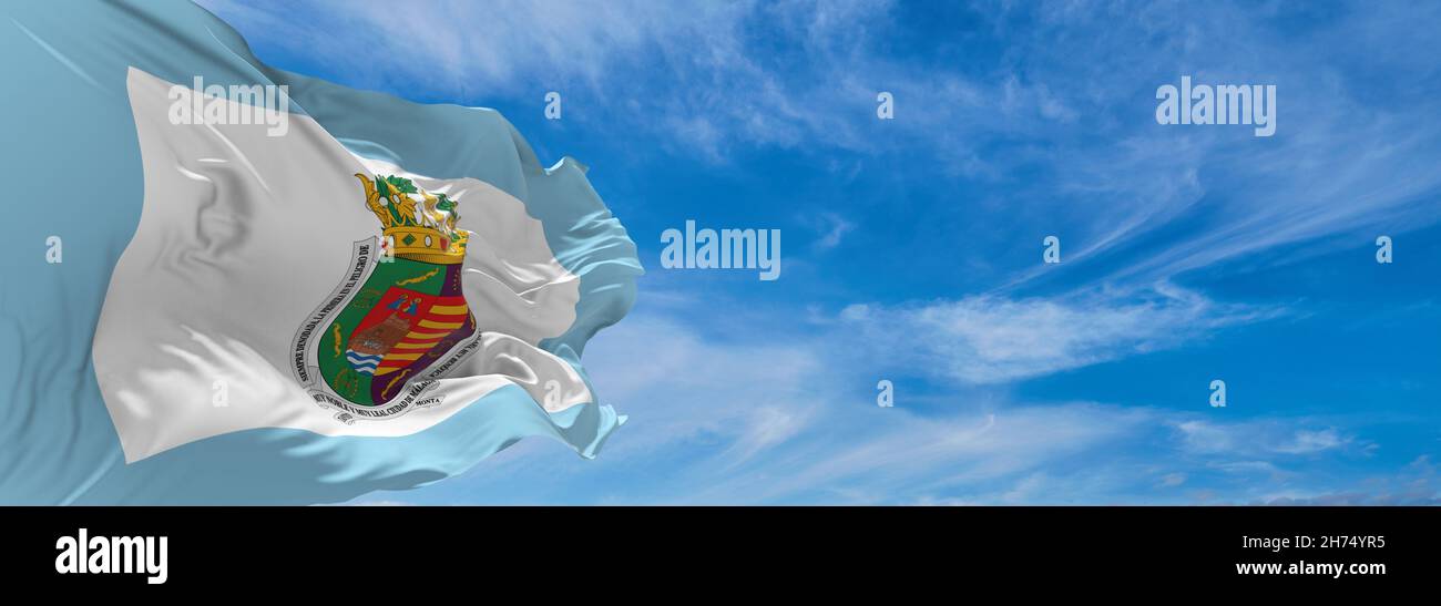 flag of Malaga Province , Spain at cloudy sky background on sunset ...