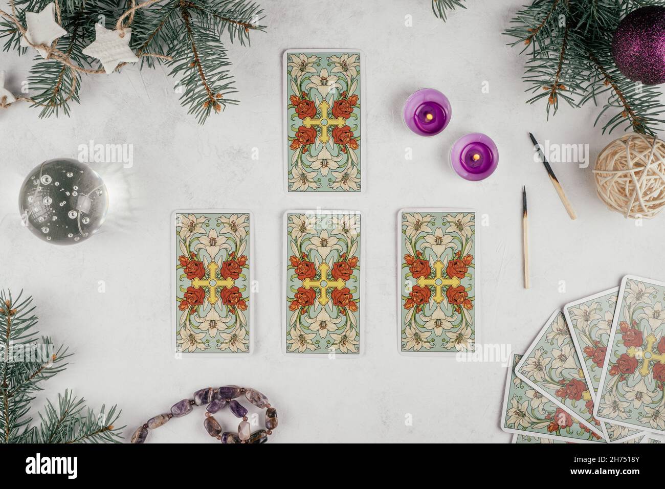 Tarot cards spread on white concrete surface with Christmas tree ...