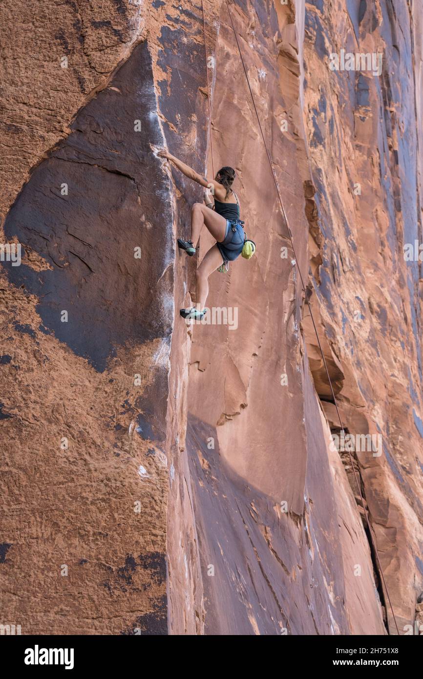 A woman rock climber on the very difficult Under the Boardwalk route on ...