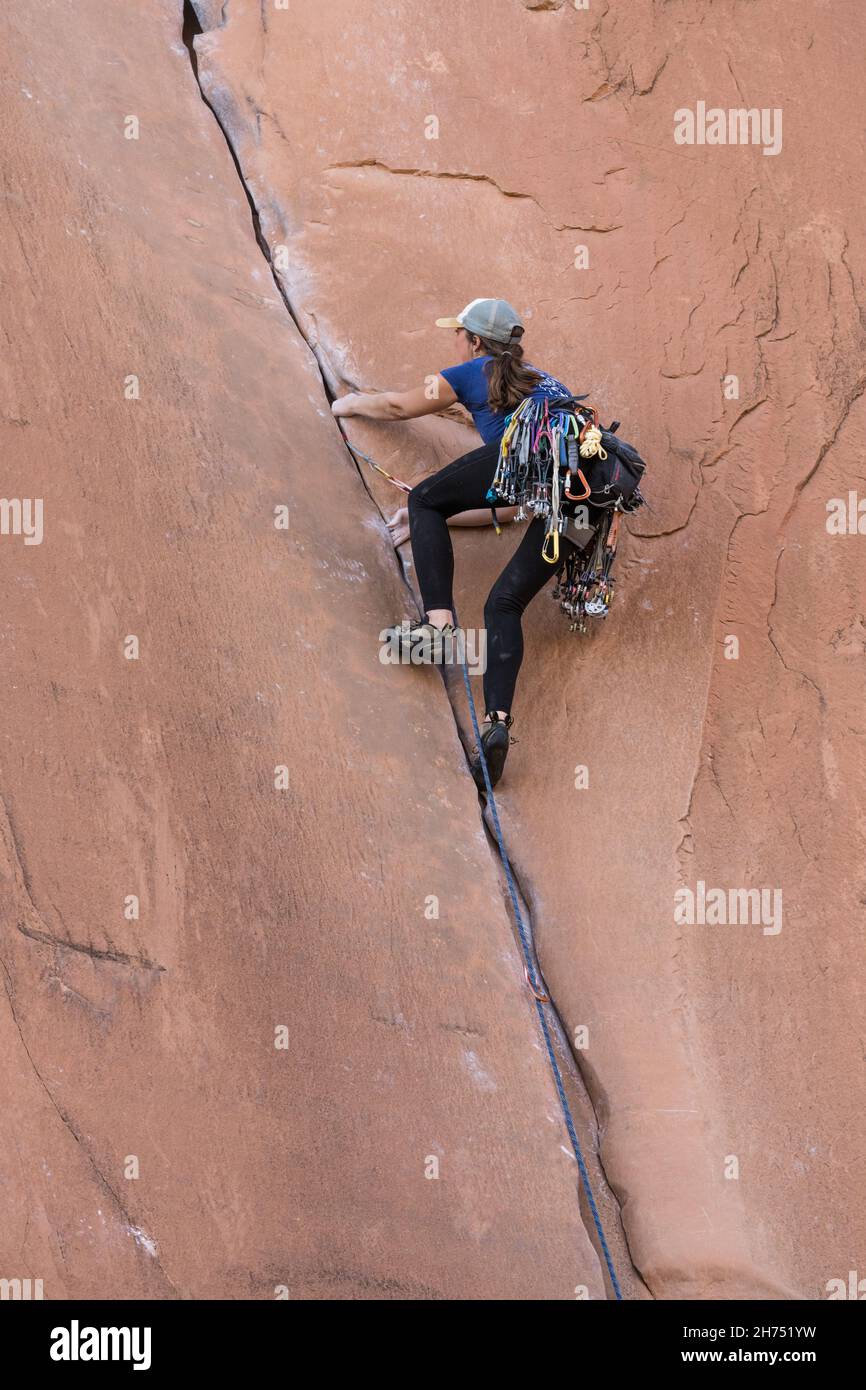 A female lead clmber climbs a crack called the Flakes of Wrath, Wall ...