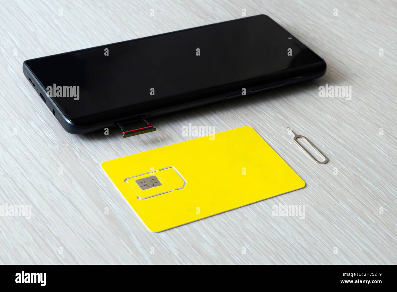 SIM card and microSD card tray with removal tool at the side of ...