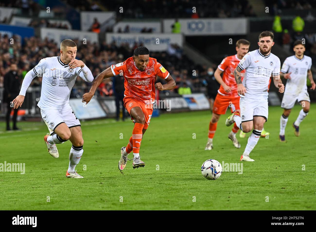 Demi Mitchell #15 of Blackpool and Matt Grimes #8 of Swansea City chase ...