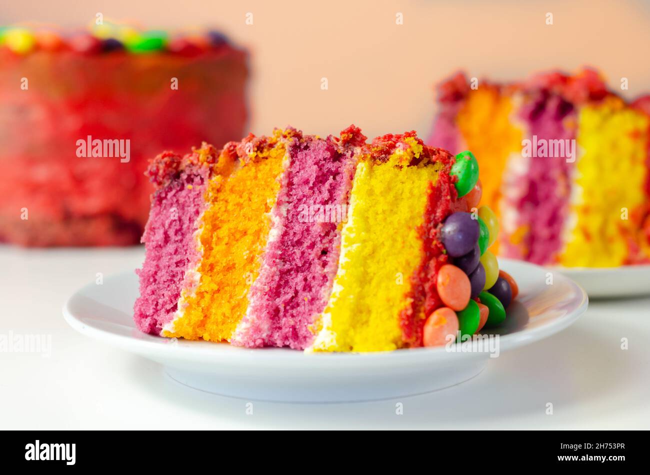 Rainbow celebration cake, coloured sponge cake filled and covered with ...
