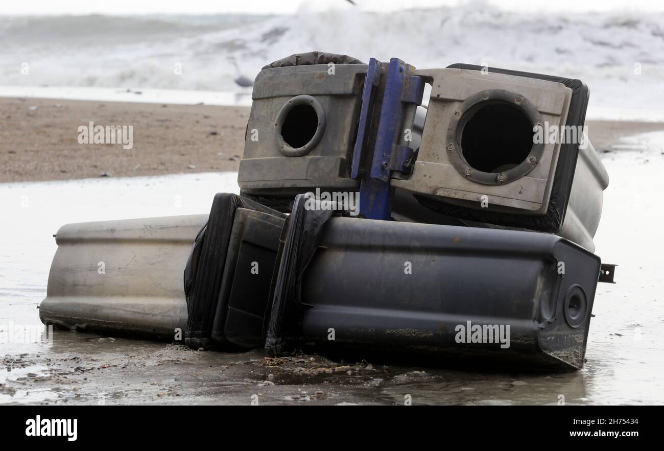garbage cans thrown on the beach, strong tides, climate change Stock ...