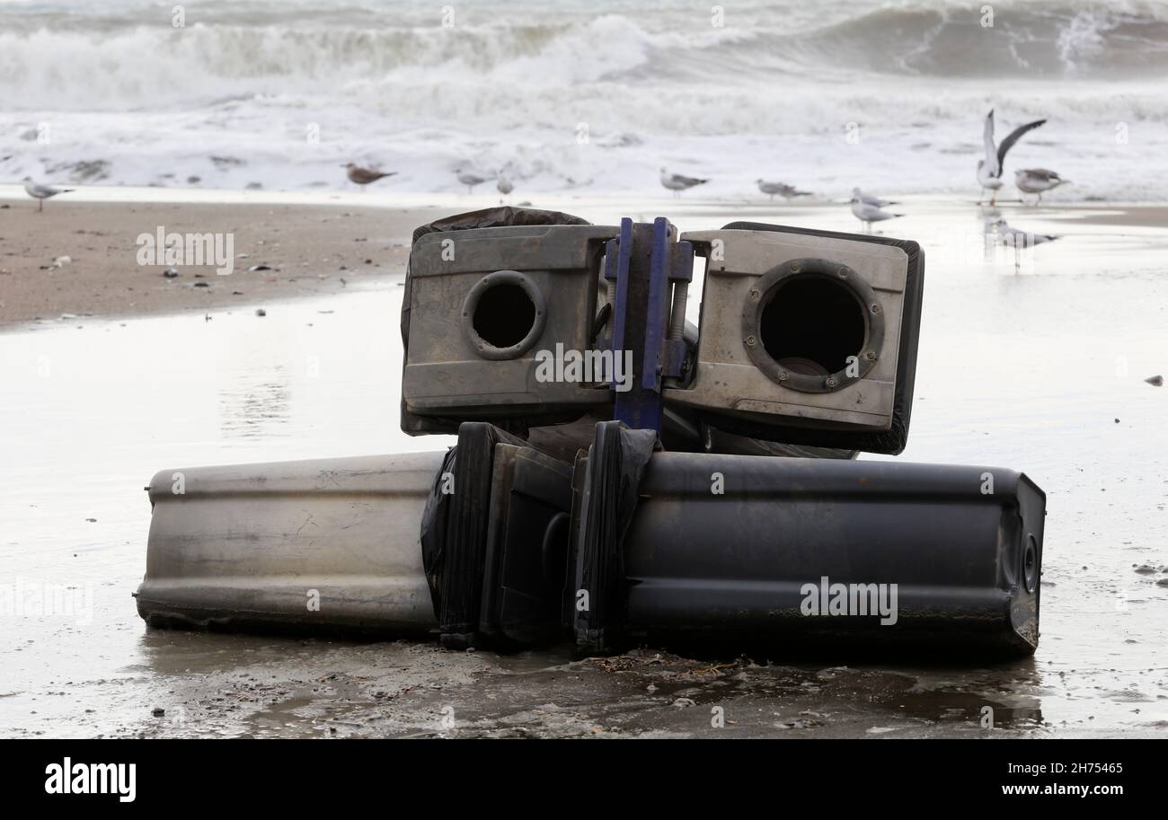 garbage cans thrown on the beach, strong tides, climate change Stock ...