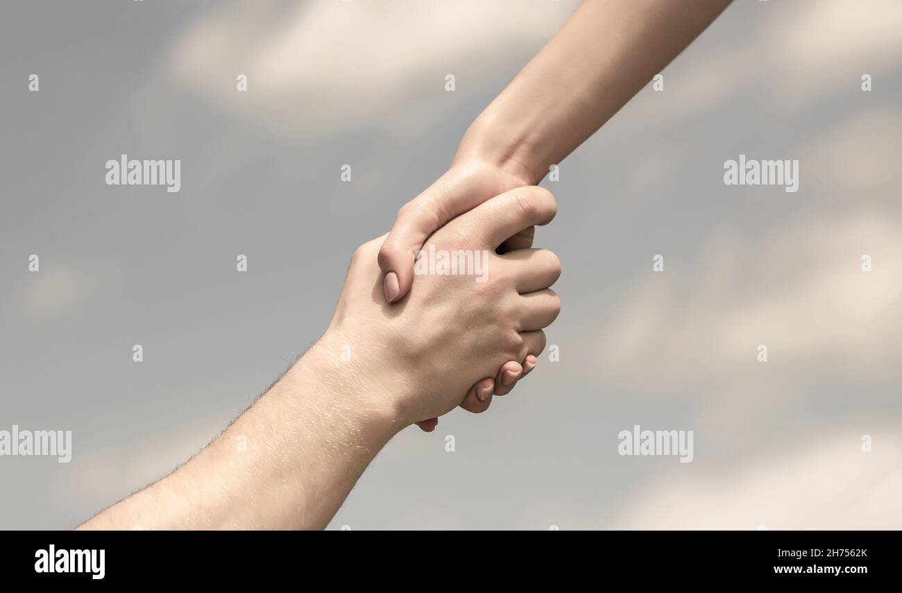 Hands of man and woman reaching to each other, support. Giving a ...