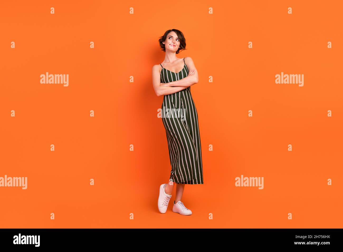 Full length body size view of attractive dreamy cheery girl folded arms ...