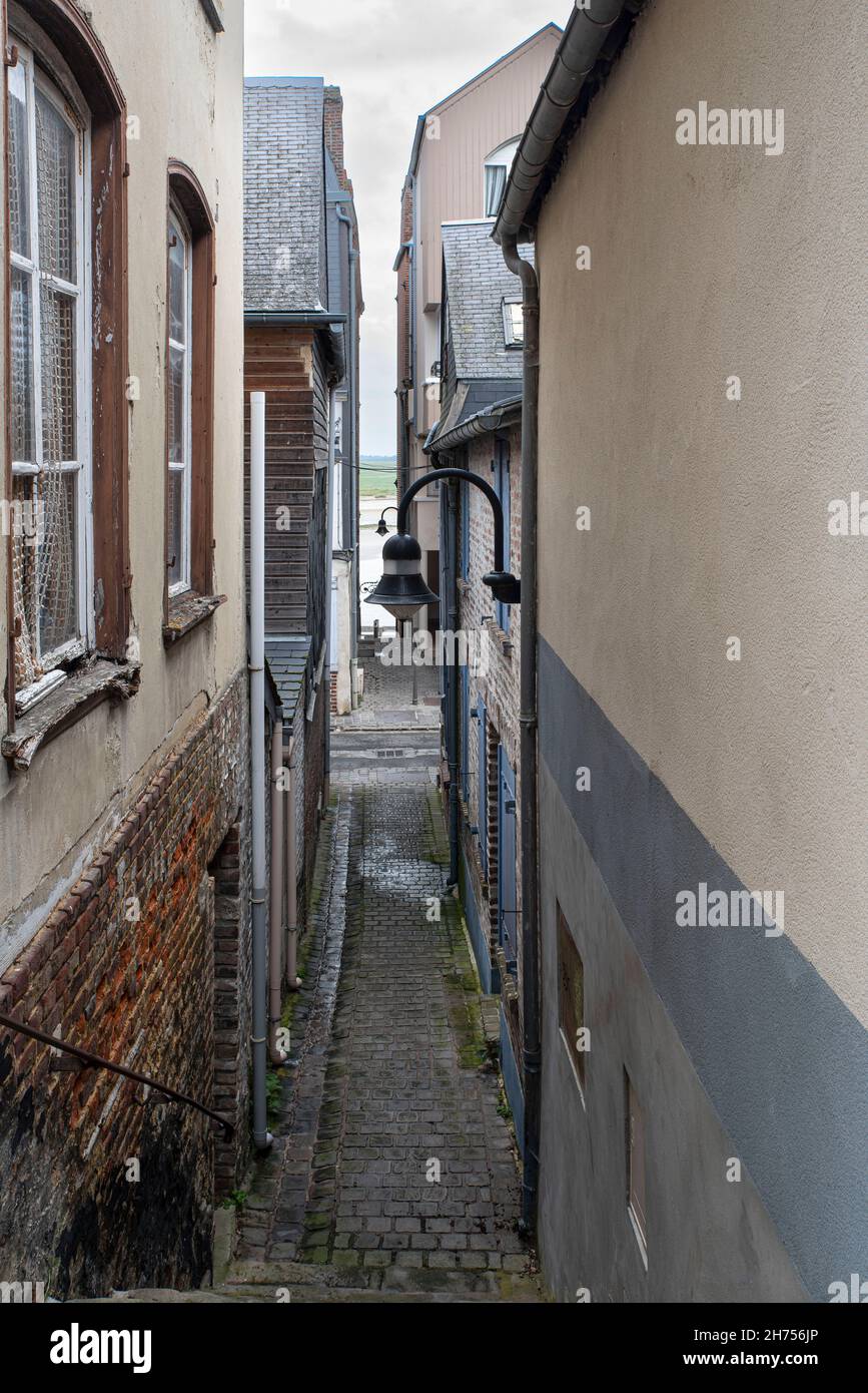 Narrow passage between old houses with a view of the sea in the ...