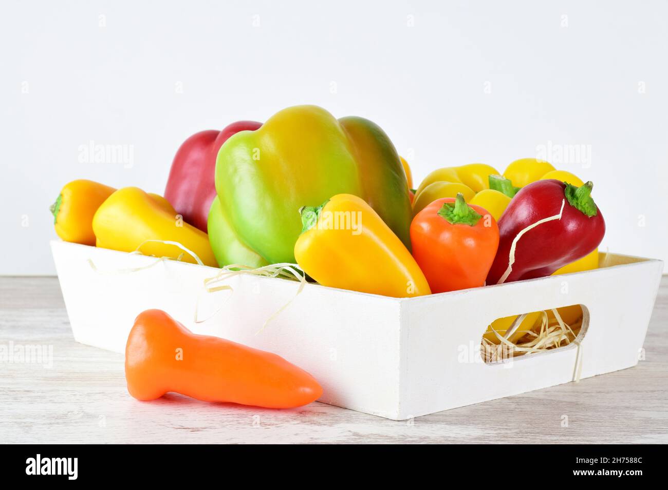 Wooden tray full of colorful peppers in the light background Stock ...