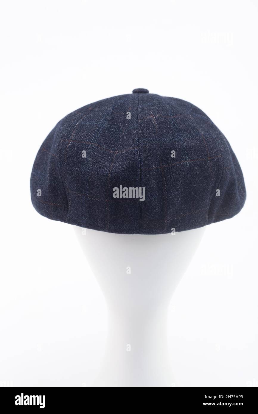 Back view a dark blue checkered peaked cap with a visor on the head of ...