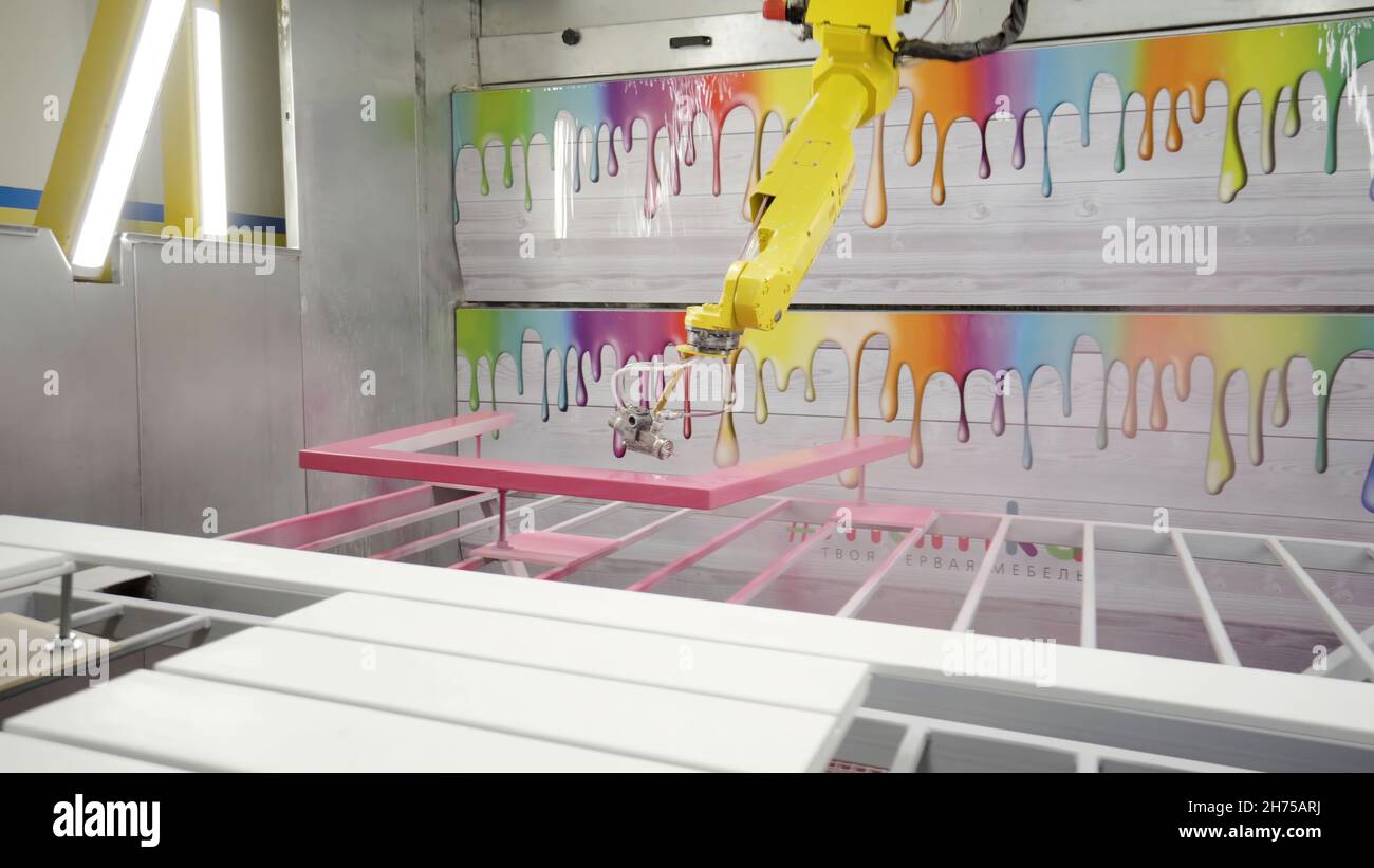 Industrial robotic arm paints frame. Action. Modern equipment for ...