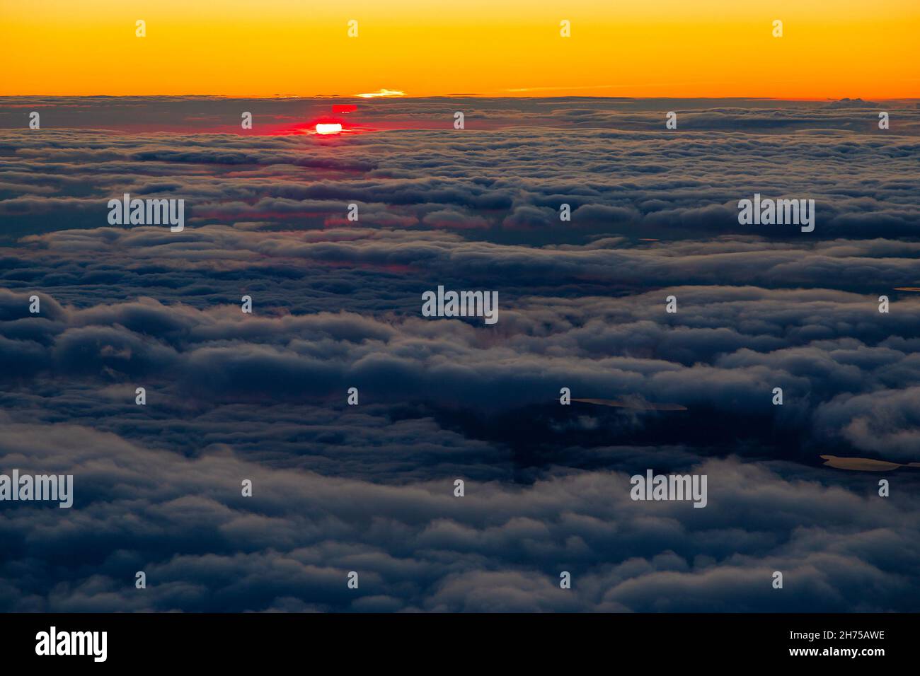 Stunning aerial view of stratus clouds on sunset background. Red eye of ...