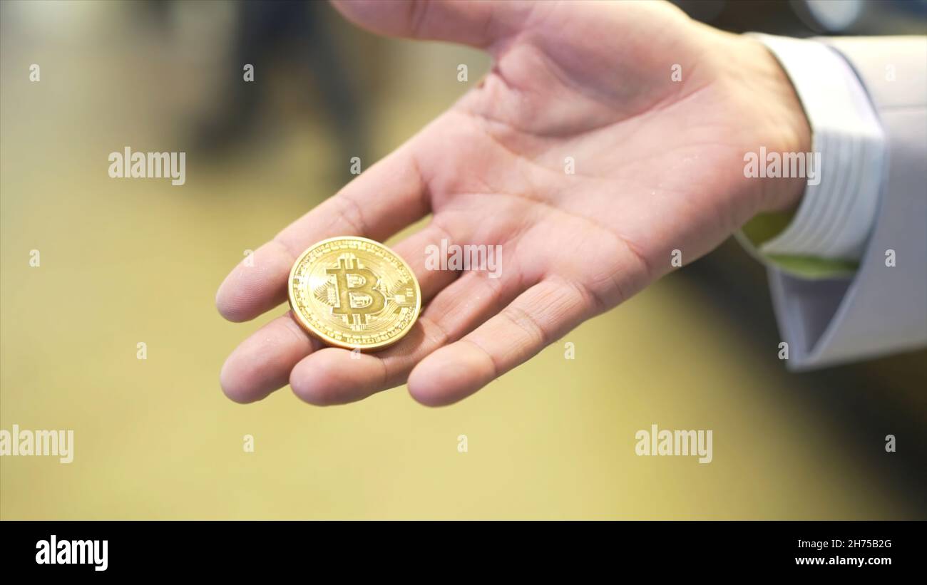 Businessman hold golden Bit coin Ticker Symbol BTC, finance money ...