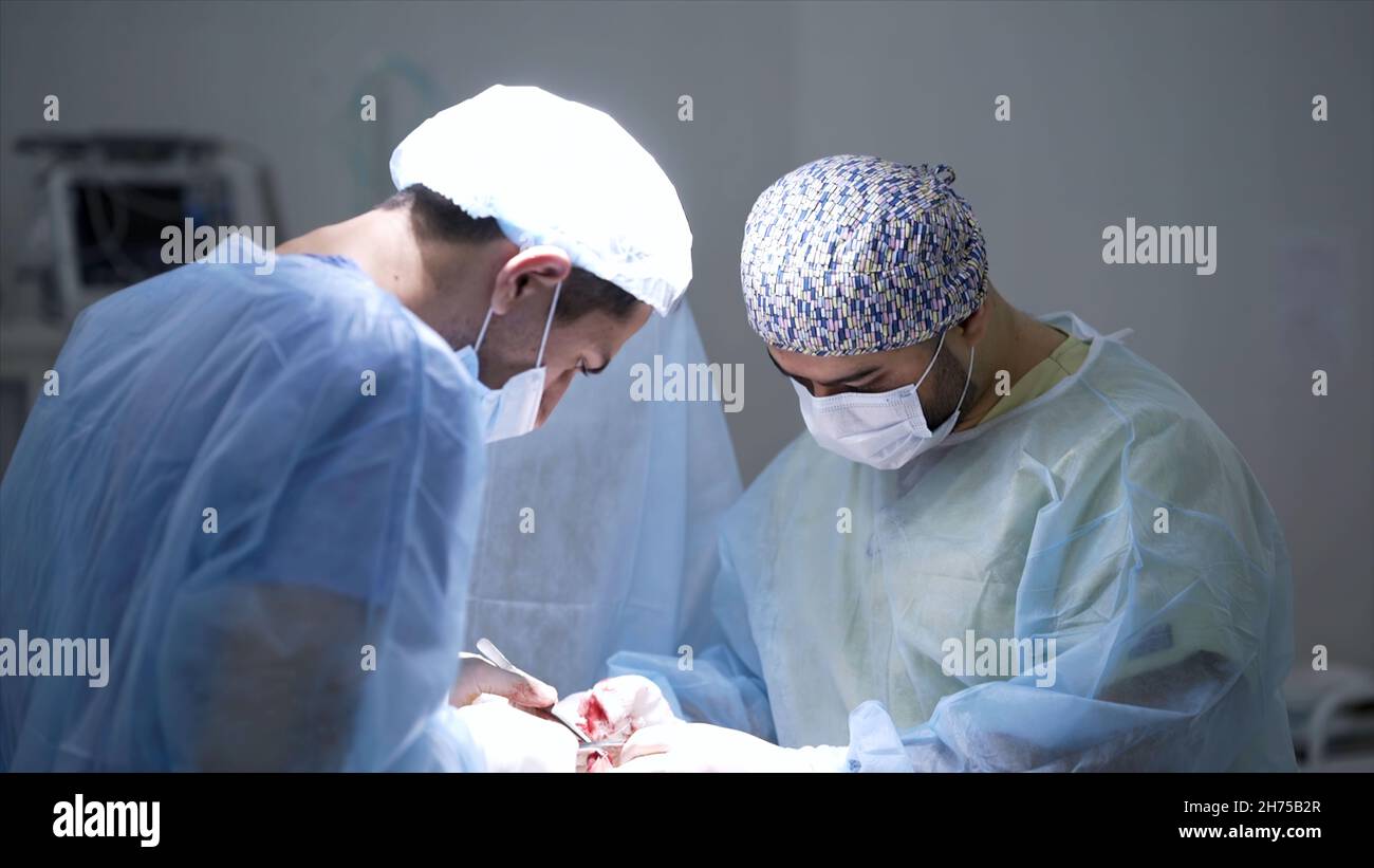 Surgeons cauterize wounds. Action. Professional surgeons carry out ...
