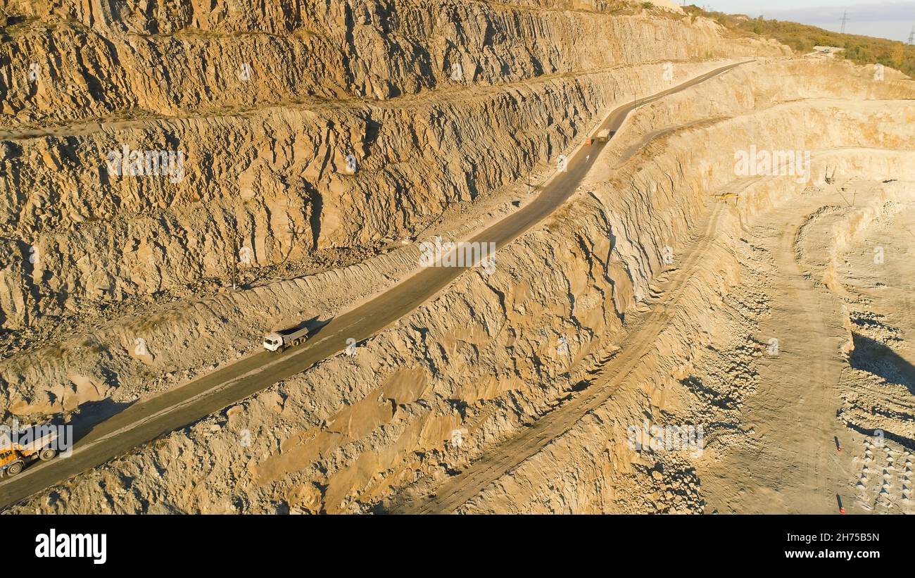 Top view of quarry with trucks. Shot. Multistage pit wall for mining ...