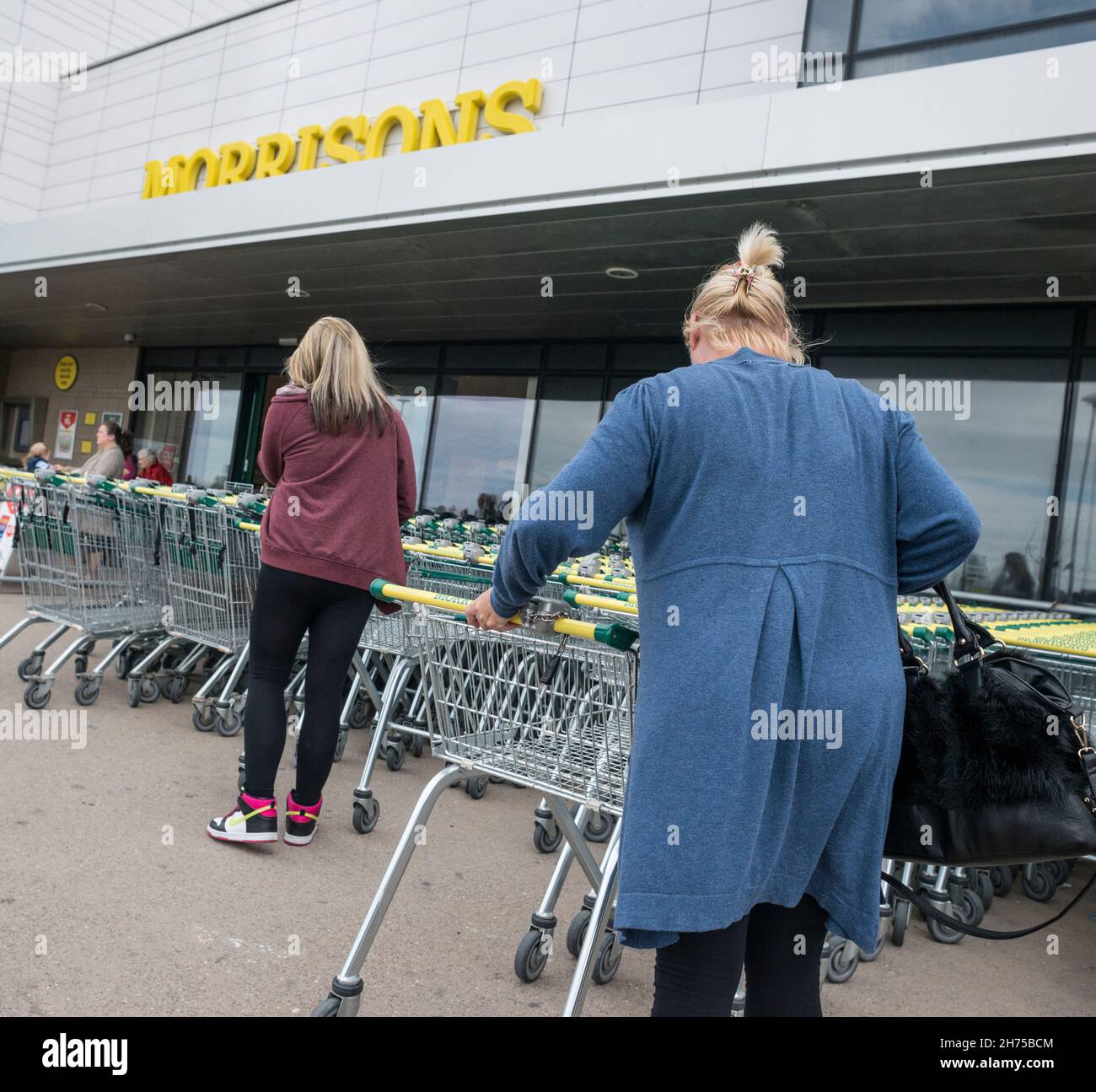 Shoppers collecting shopping trollies at Morrisons Supermarket ...