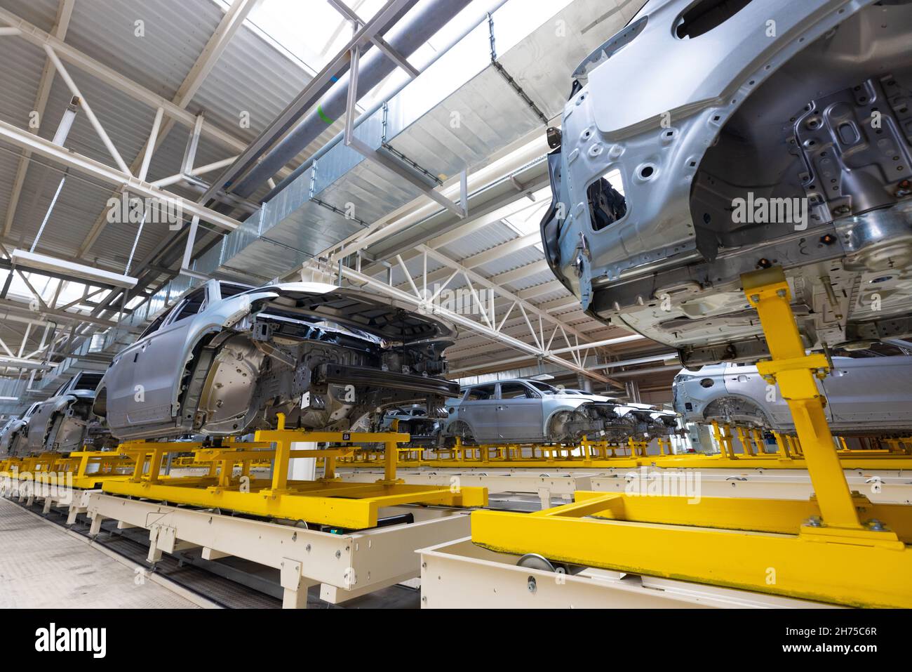 Car bodies are on assembly line. Factory for production of cars. Modern ...