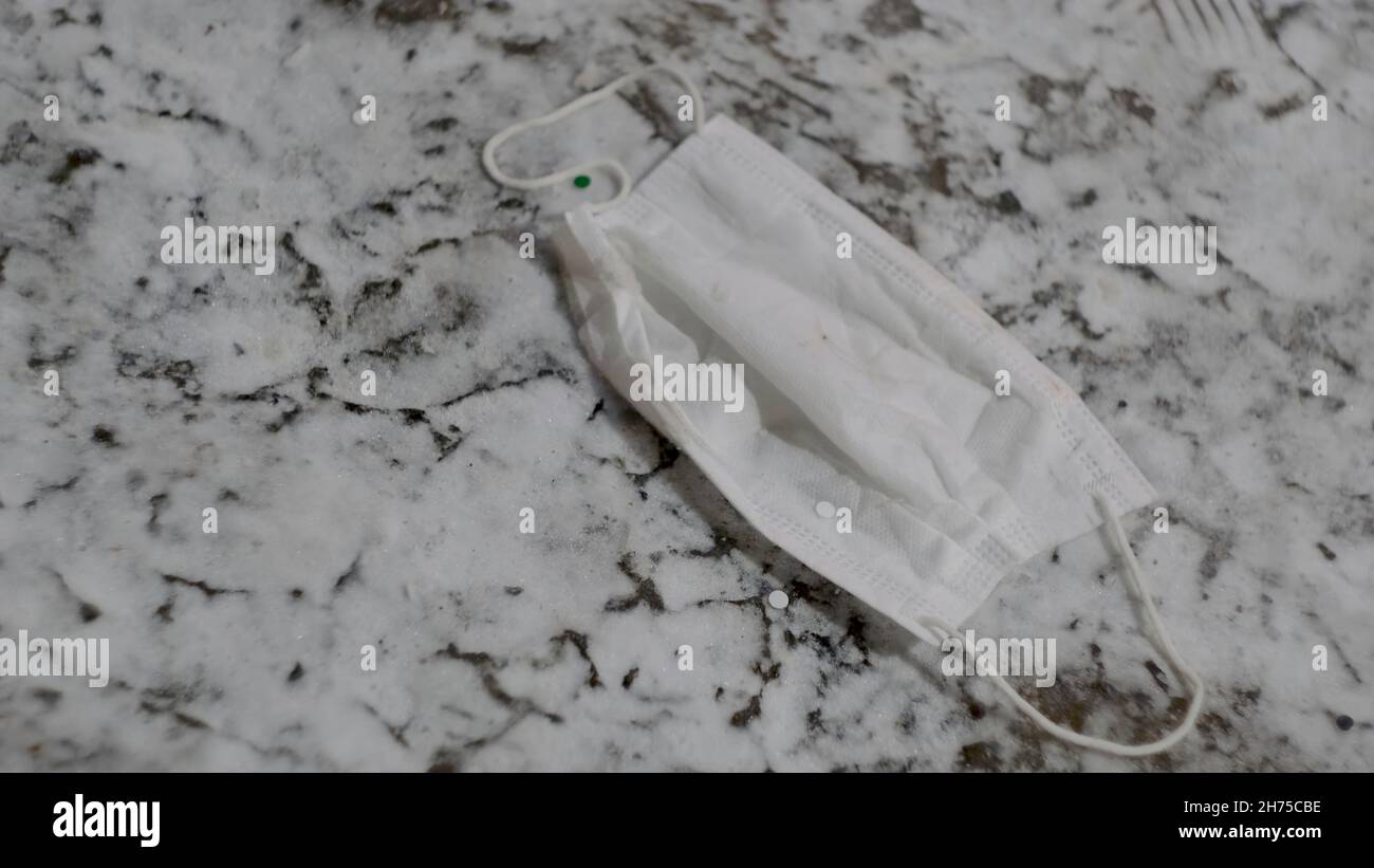 Medical mask being stepped on. Concept. Close-up of medical mask lying ...