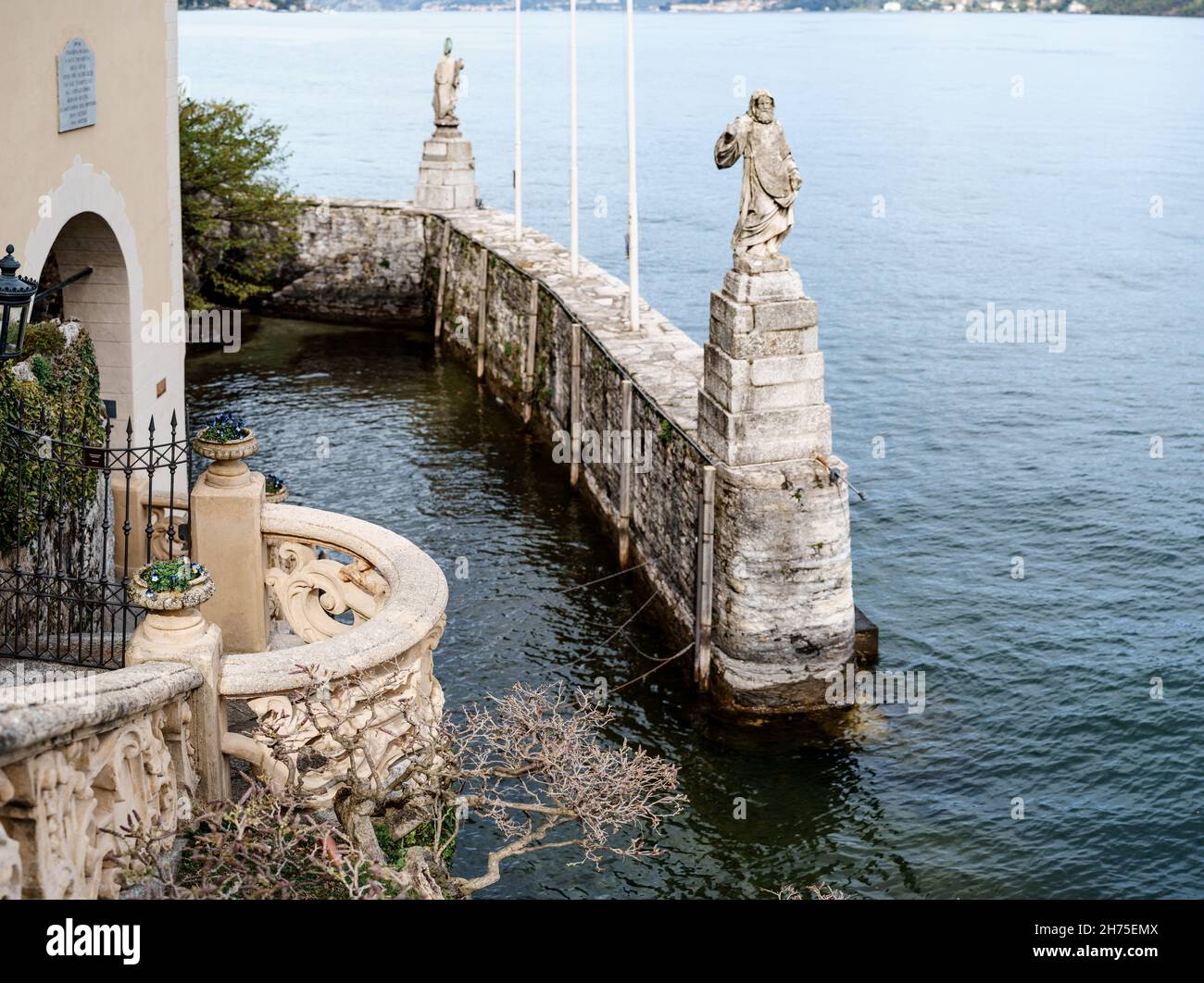 Stone statues on pedestals in the water in front of the balcony of ...